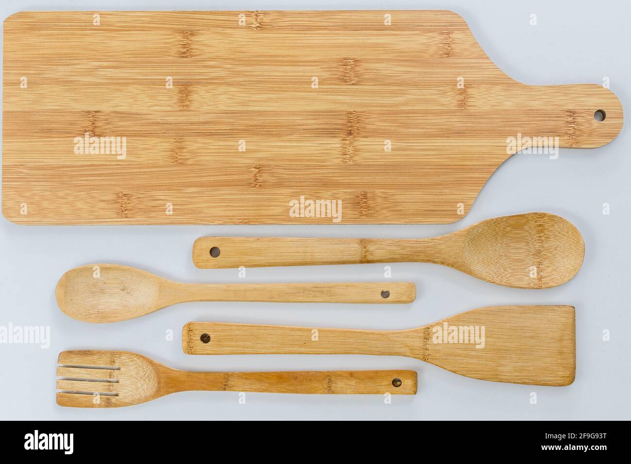 A top view of wooden kitchen spoon and spatula set and other utensils ...