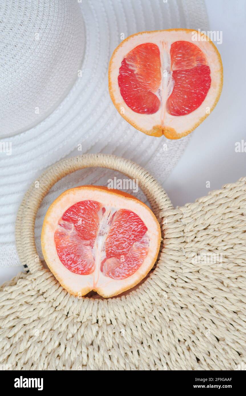 straw bag white hat and red juicy graipfruit for summer vacation Stock ...