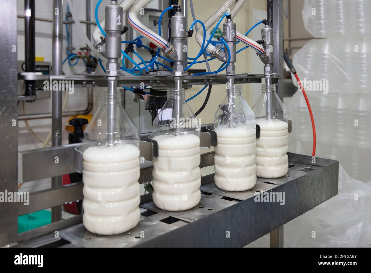 Filling milk into plastic bottles at the factory. equipment in dairy ...