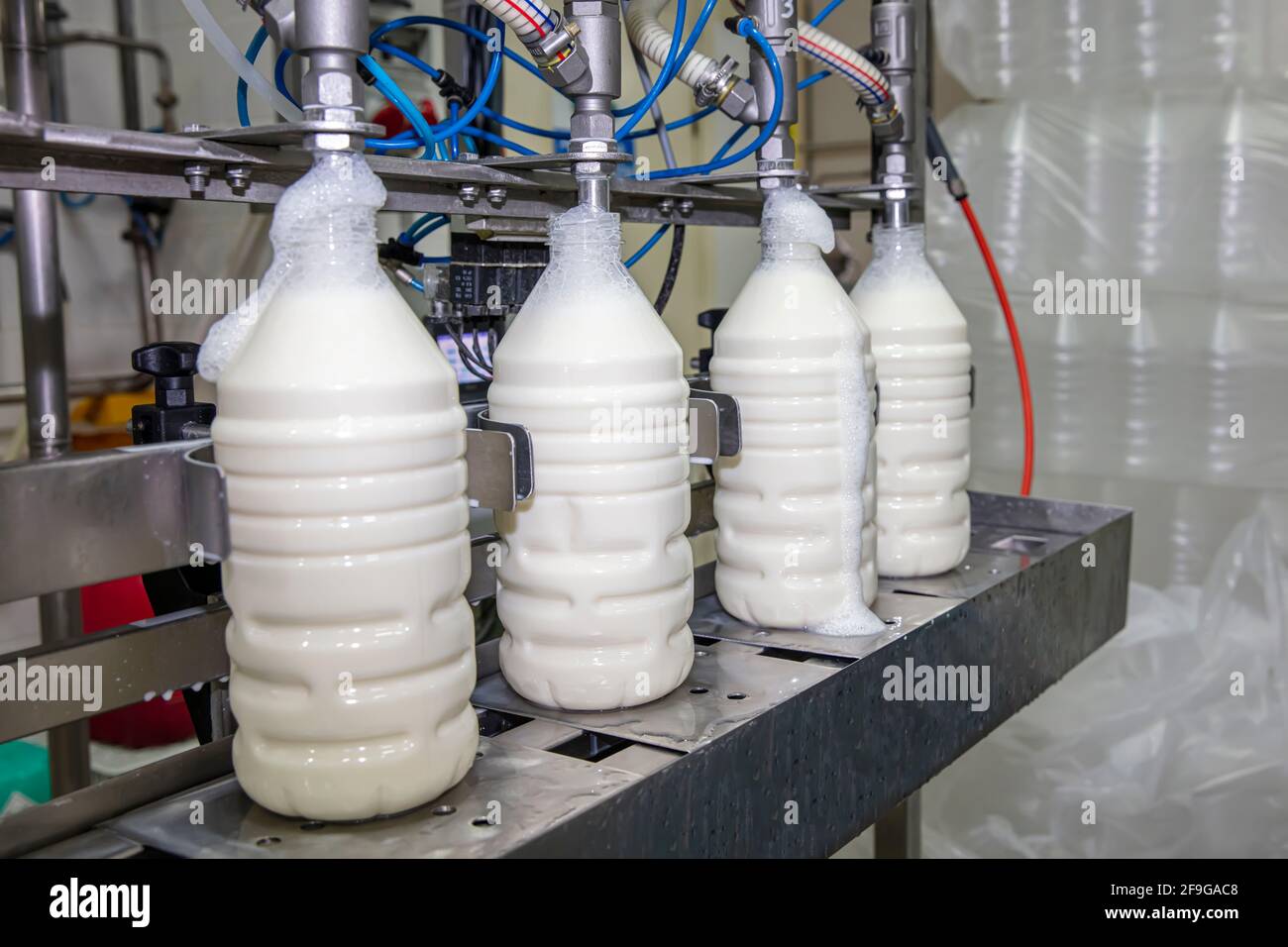 Filling milk into plastic bottles at the factory. equipment in dairy ...
