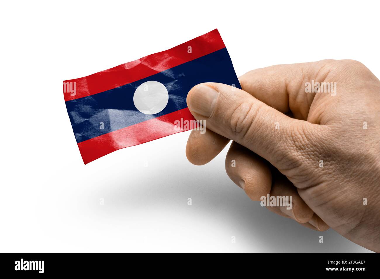 Hand holding a card with a national flag the Laos Stock Photo - Alamy