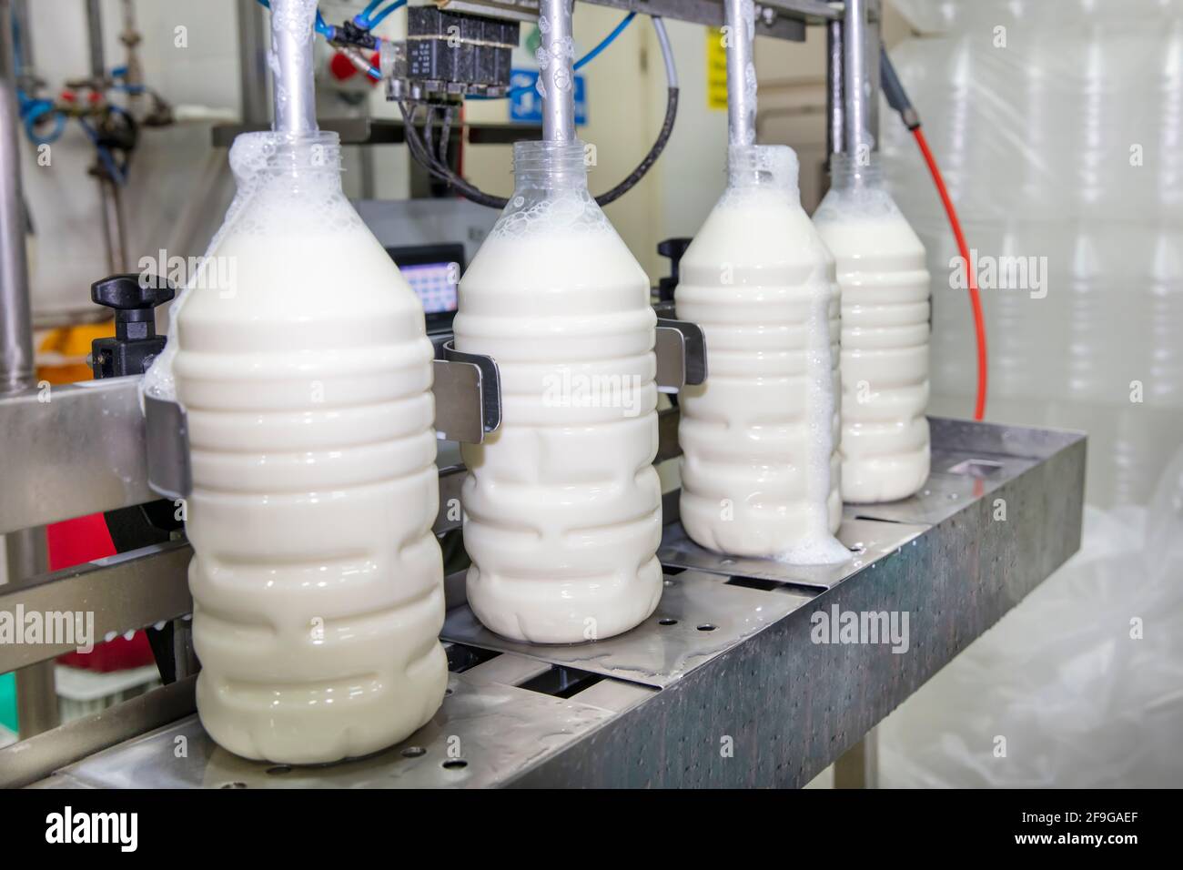 Filling milk into plastic bottles at the factory. equipment in dairy ...