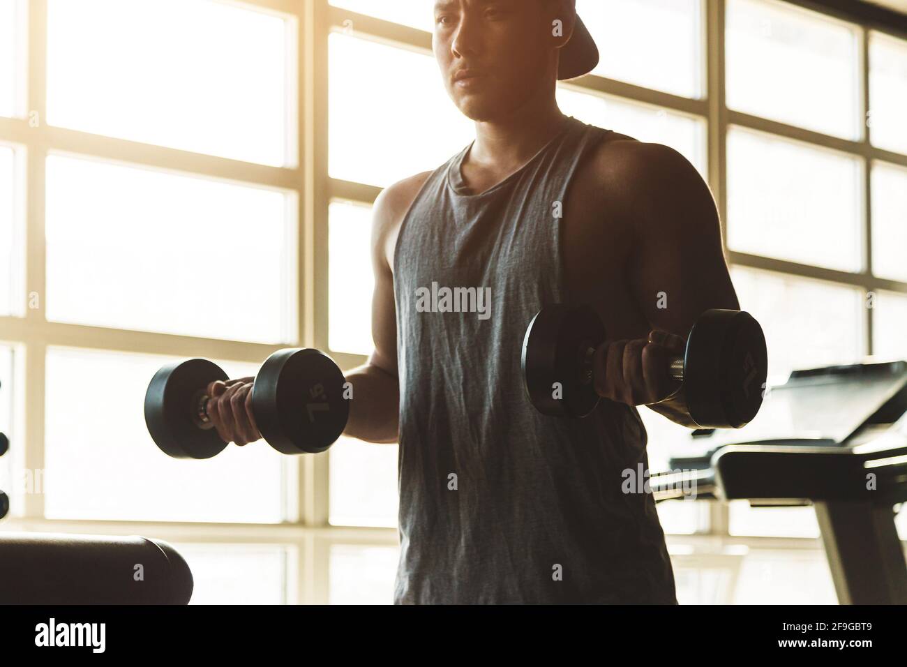 Portrait of a muscular man performs exercises in the gym. Strength ...