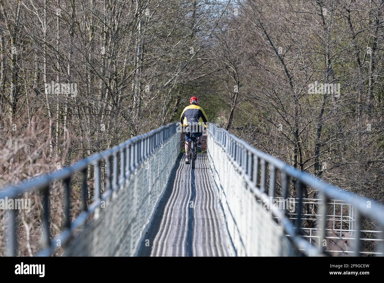 Cyclist on cycle route 7 crossing Endrick Water on the metal pipe ...