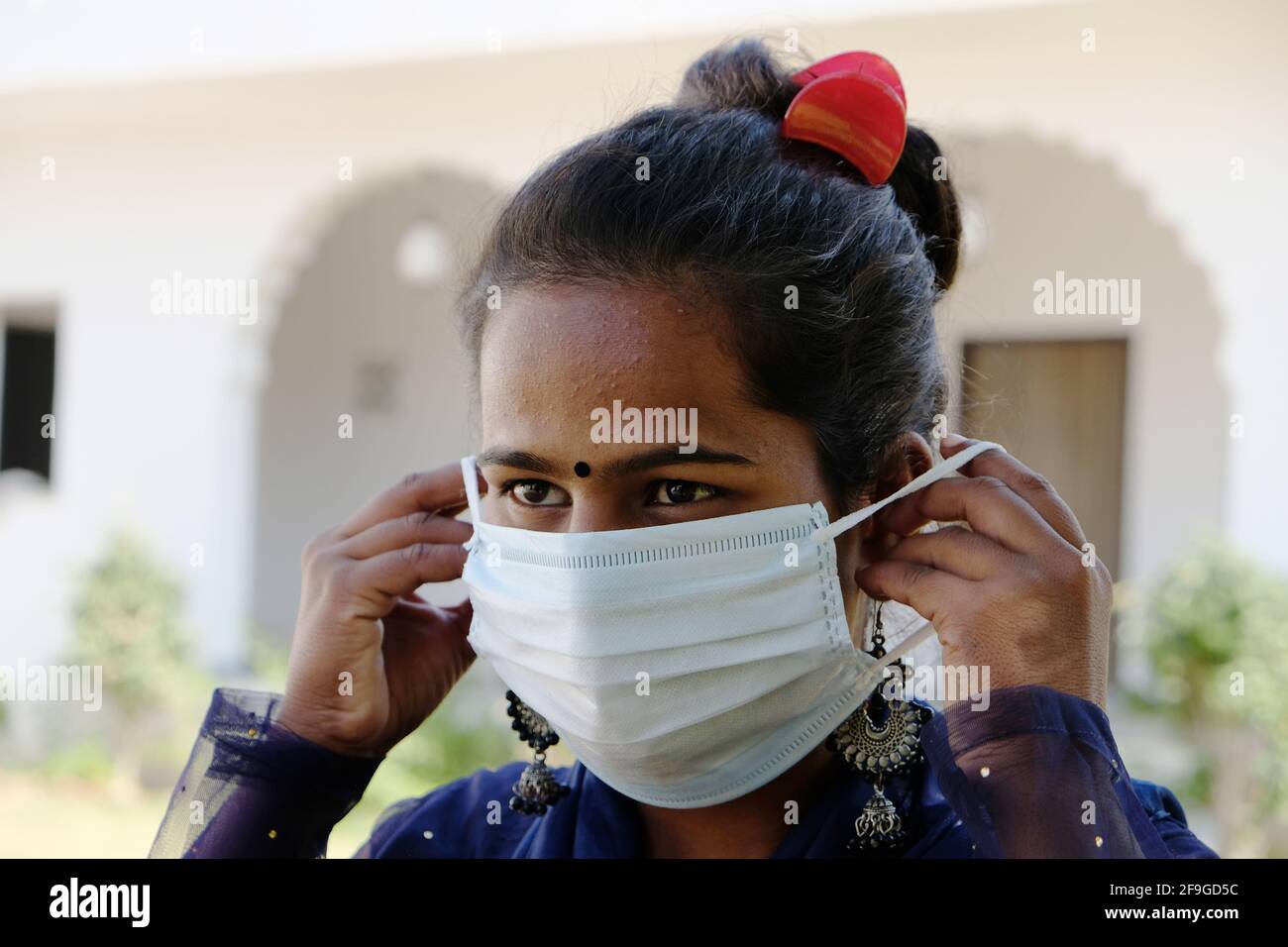 A shallow focus of a young Indian woman with a bindi on her forehead ...