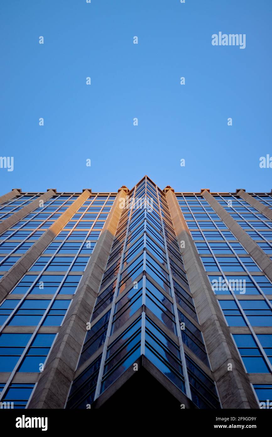 A low angle shot of a modern office building under the sunlight and a ...