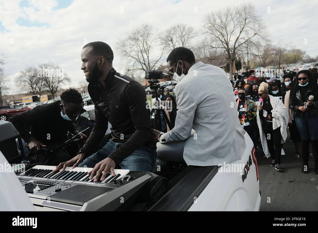 Members of a church group play piano, sing hymns and lead a march in ...