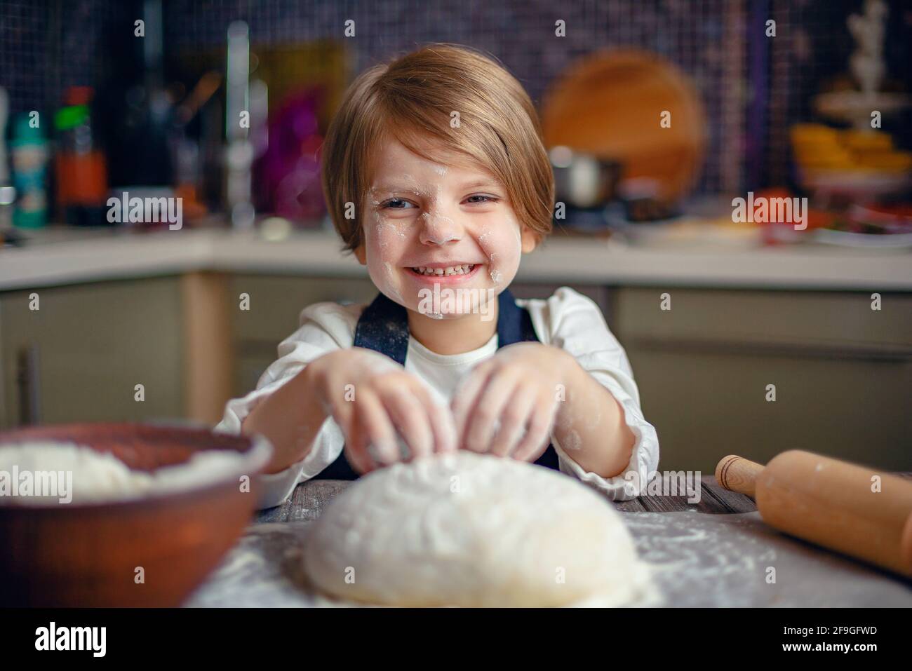 Little child girl with short hair haircut cooking dough Stock Photo - Alamy