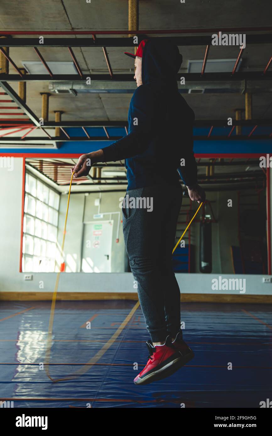 Young athlete man jumping rope in the training room Stock Photo - Alamy