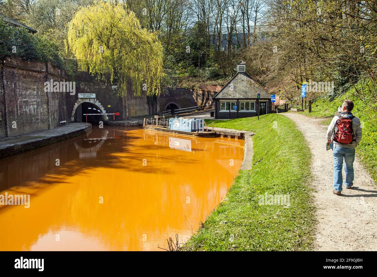 Man walking along the towpath of the Trent and Mersey canal towards the ...