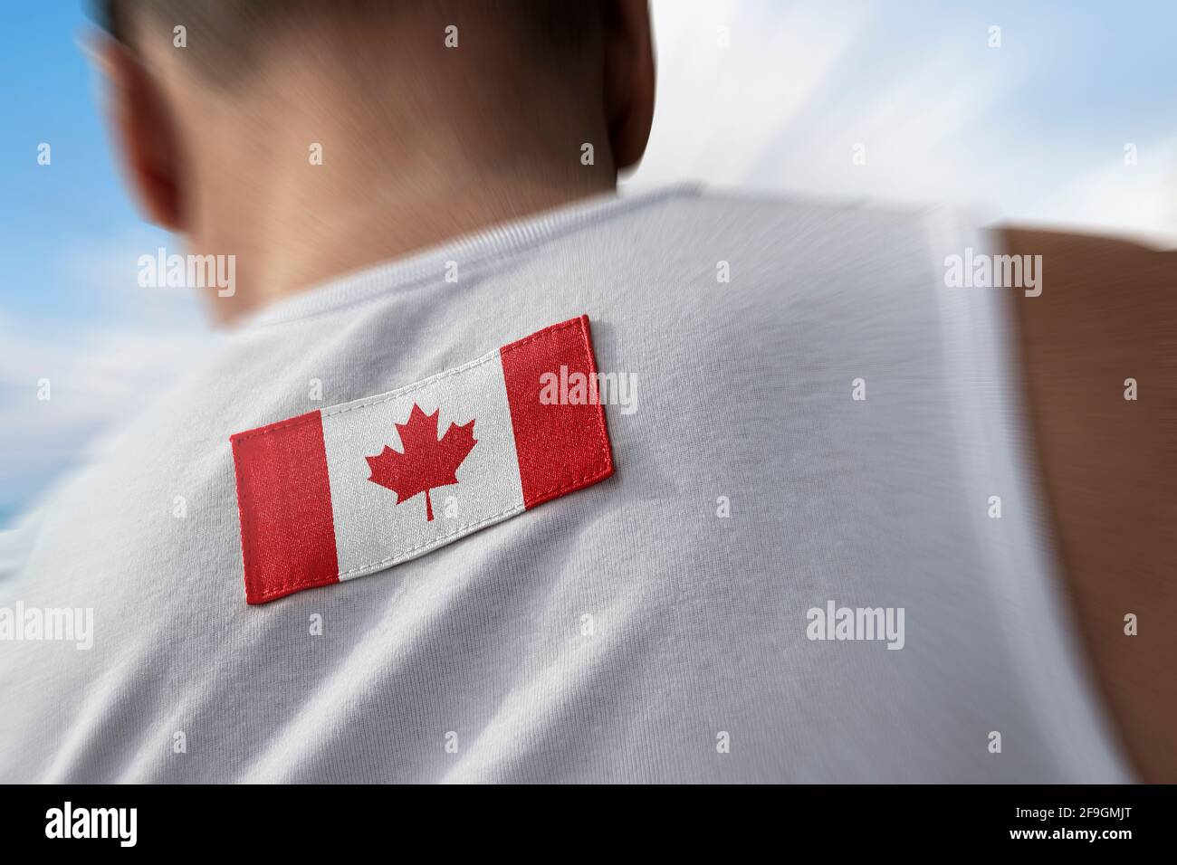 The national flag of Canada on the athlete's back Stock Photo - Alamy