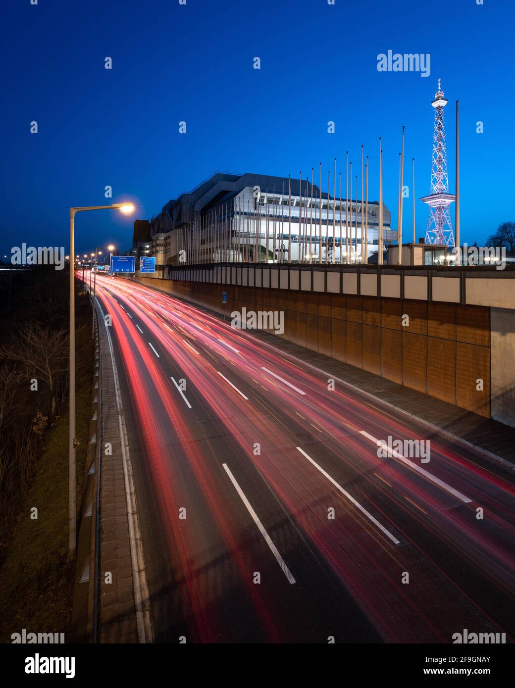 Evening traffic on the motorway at the ICC with radio tower in the ...