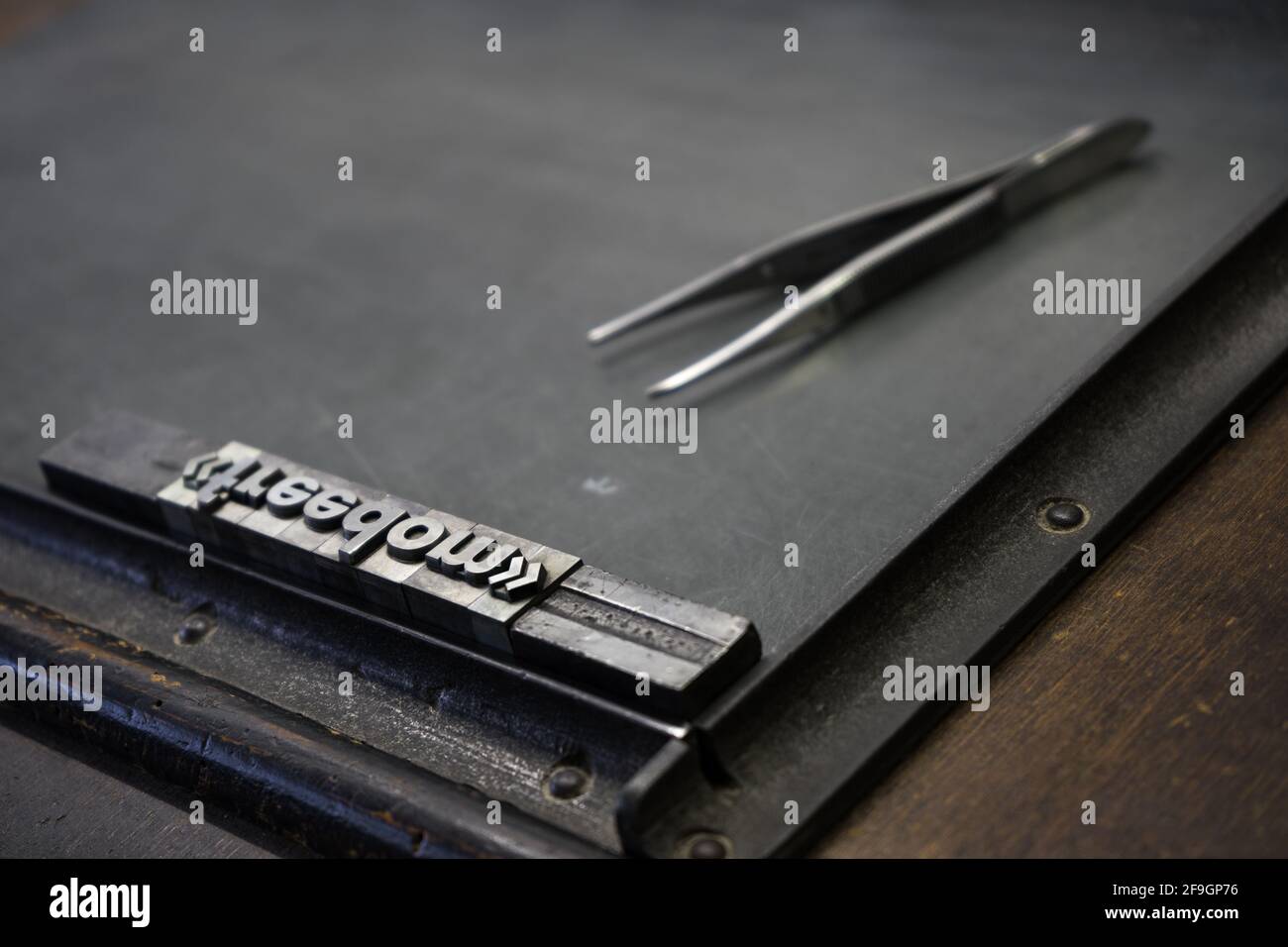 old types of printing presses, placed with clamps on an assembly frame ...