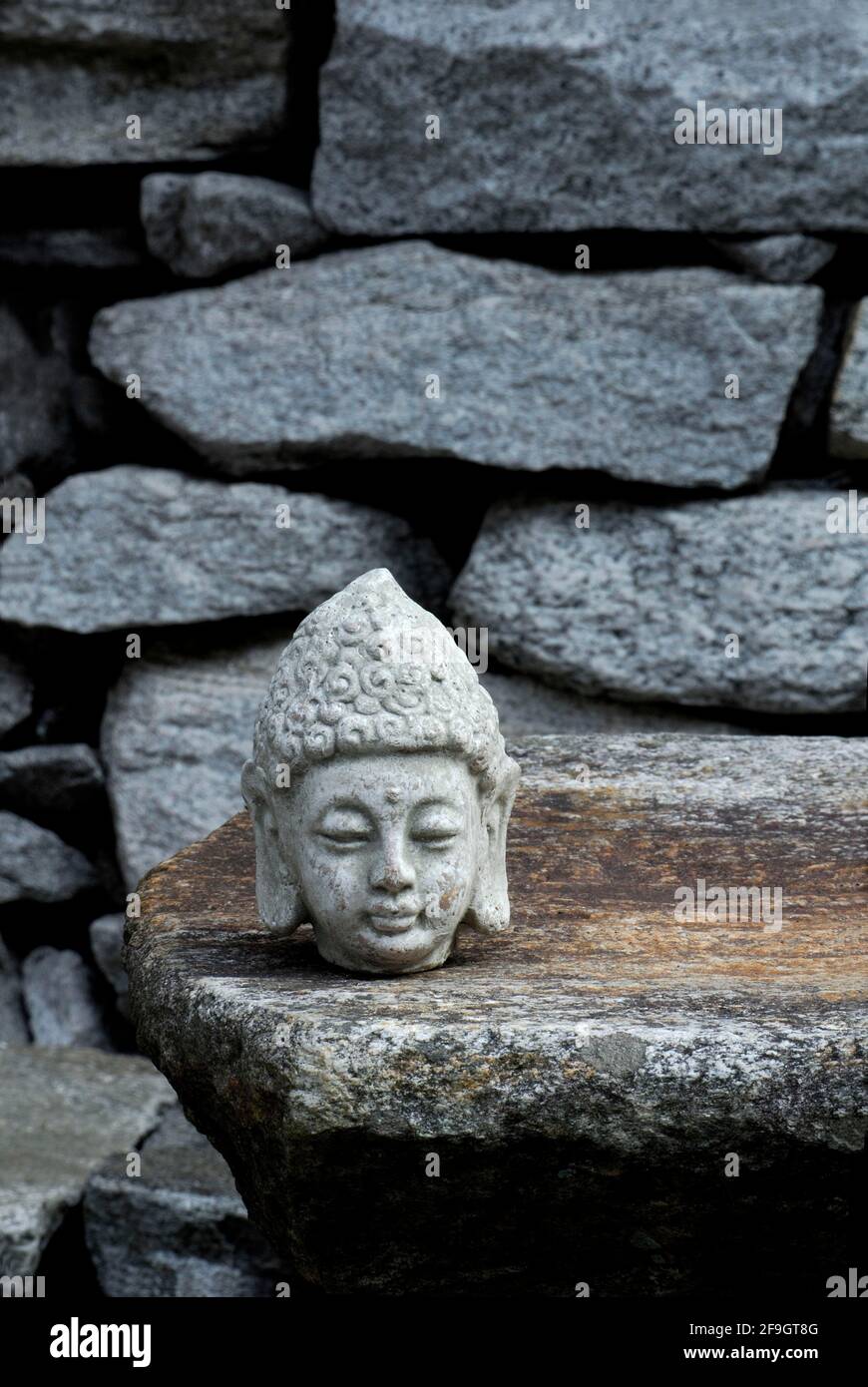 Buddha head on stone slab Stock Photo - Alamy