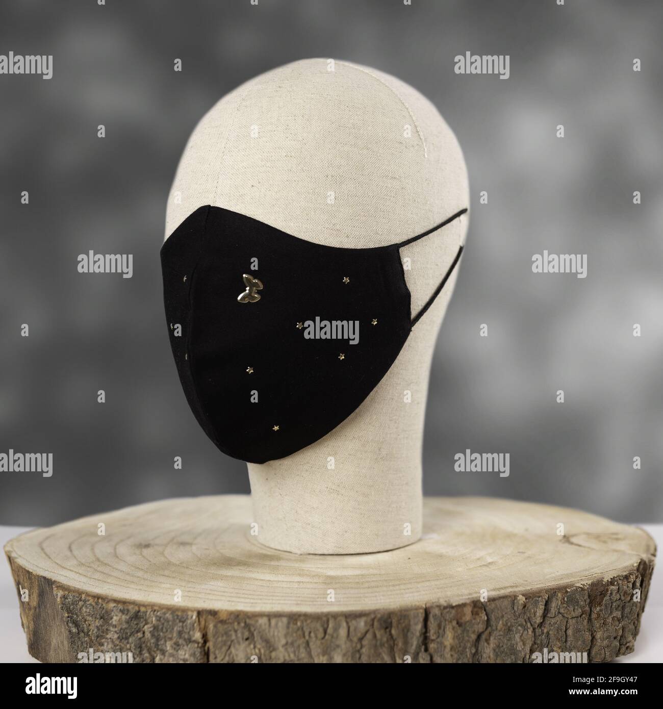 A black protective mask dotted with stars on a mannequin head Stock ...