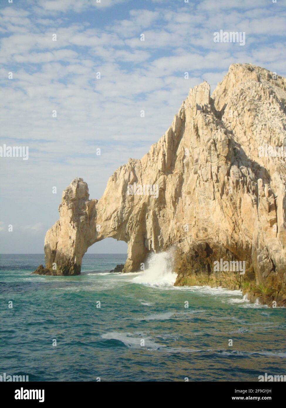 A beautiful shot of the Arch of Cabo washed by ocean waves in Mexico ...