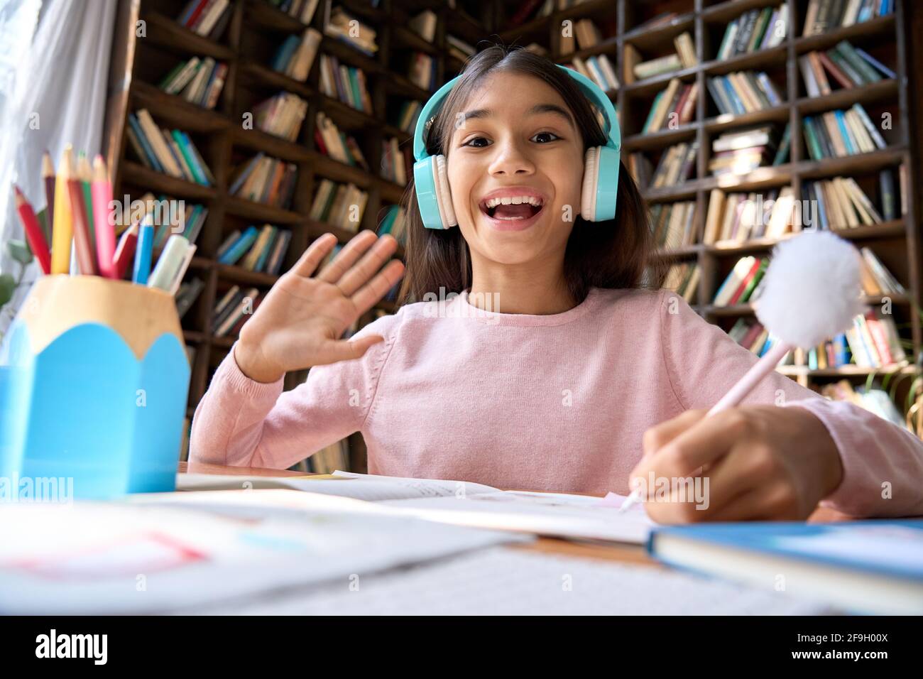 Web cam view of smiling happy indian schoolgirl on online learning ...