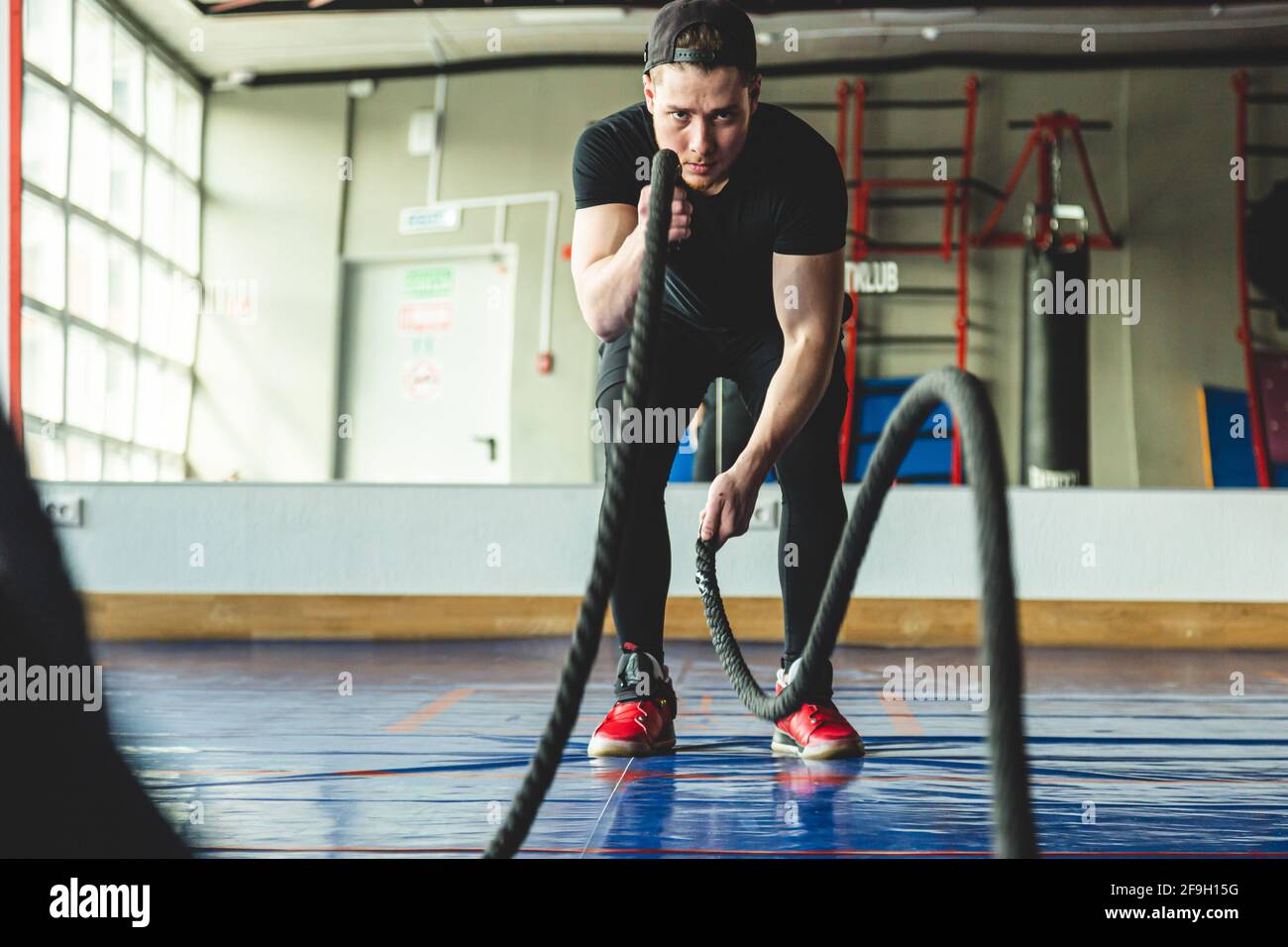 Crossfit in the gym with ropes. The athlete is training Stock Photo - Alamy