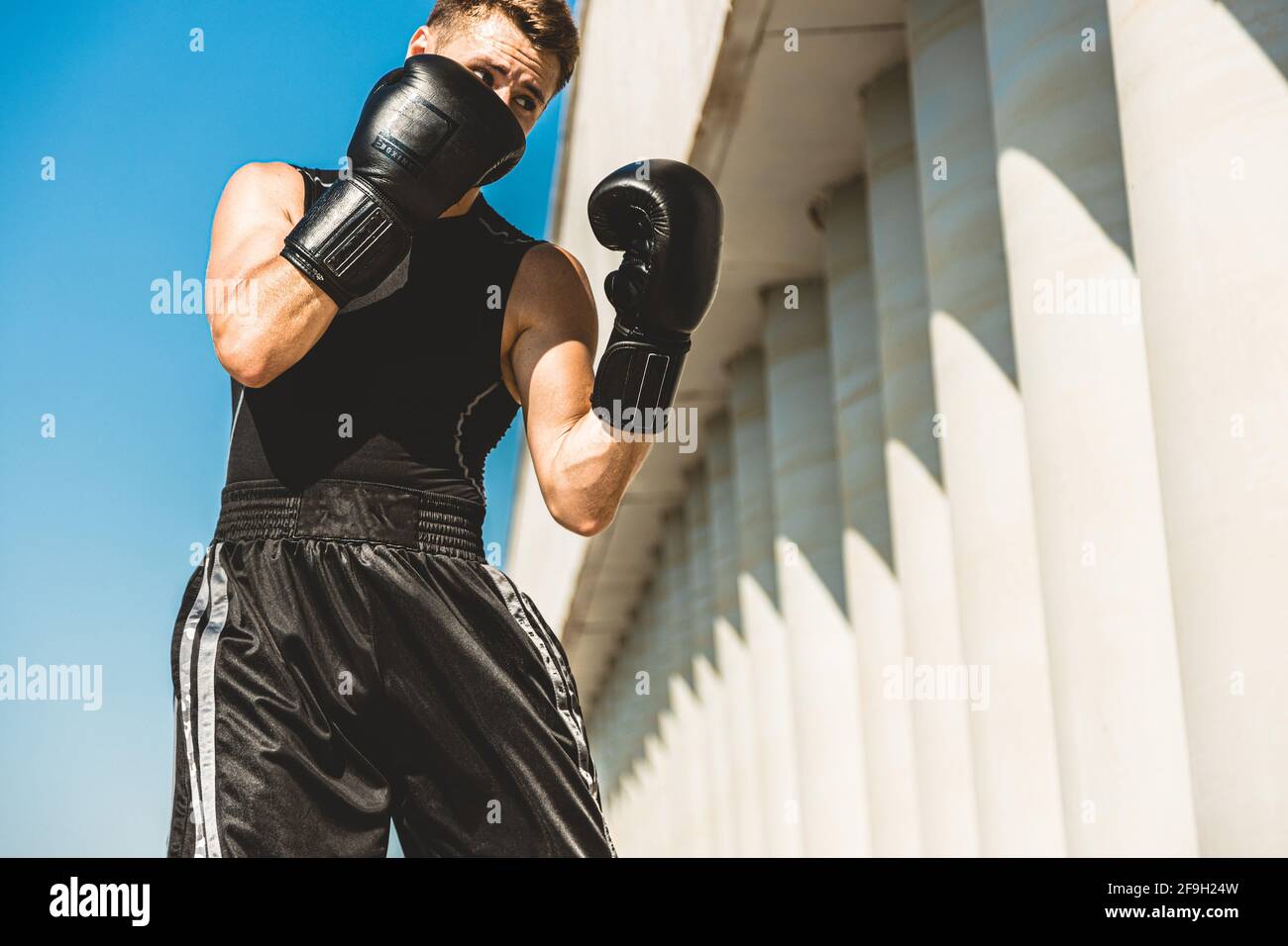 Man exercising and fighting in outside, boxer in gloves. male boxer ...