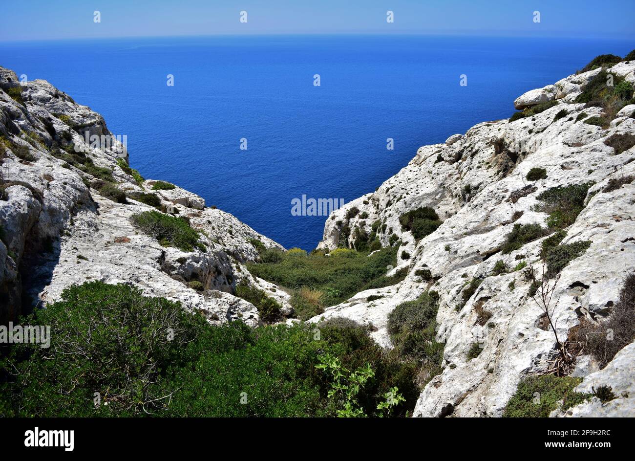 V-shaped valley along the coastal cliffs of the Maltese Islands Stock ...
