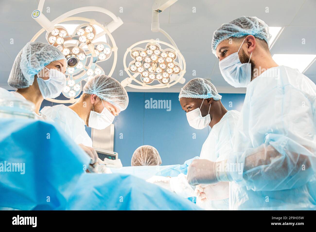 An international team of doctors performs a complex surgical operation ...
