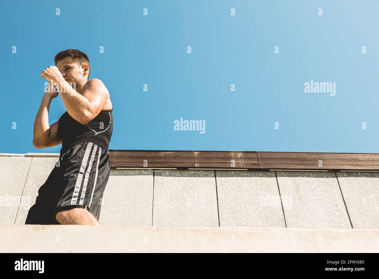 Man exercising and fighting in outside, boxer in gloves. male boxer ...