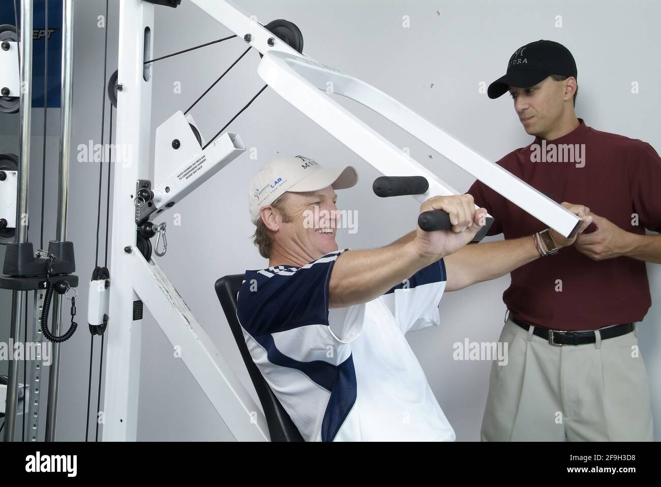 ST. LOUIS, UNITED STATES - Aug 11, 2007: A trainer helps a man with a ...
