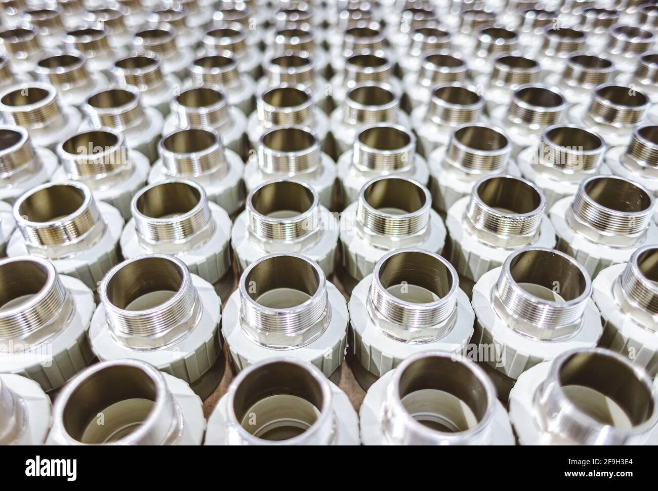 many metal pipe couplings in a pipe factory Stock Photo - Alamy
