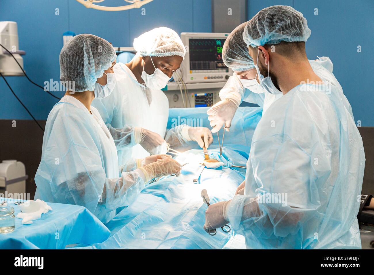An international team of doctors performs a complex surgical operation ...