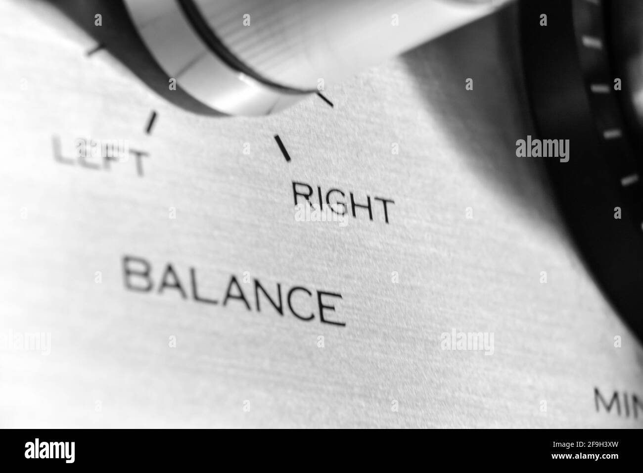 A grayscale shot of a volume tone controller with words saying "left ...