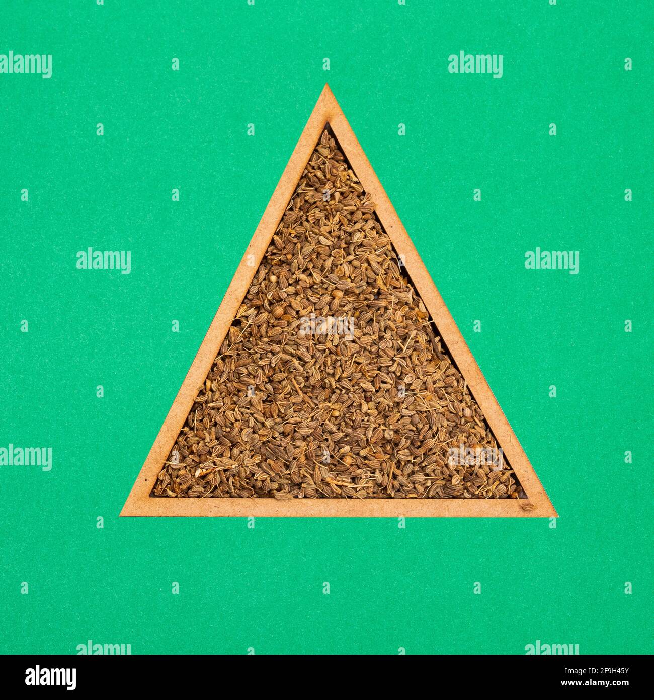 Anise seed seasoning in a triangular bowl - Pimpinella anisum Stock ...