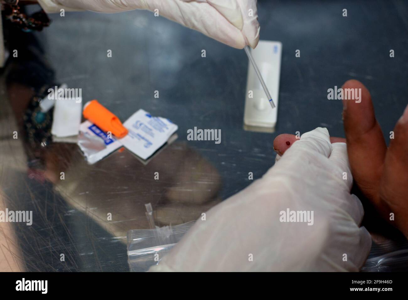 a medical personnel making a rapid test of virus c for a patient ...