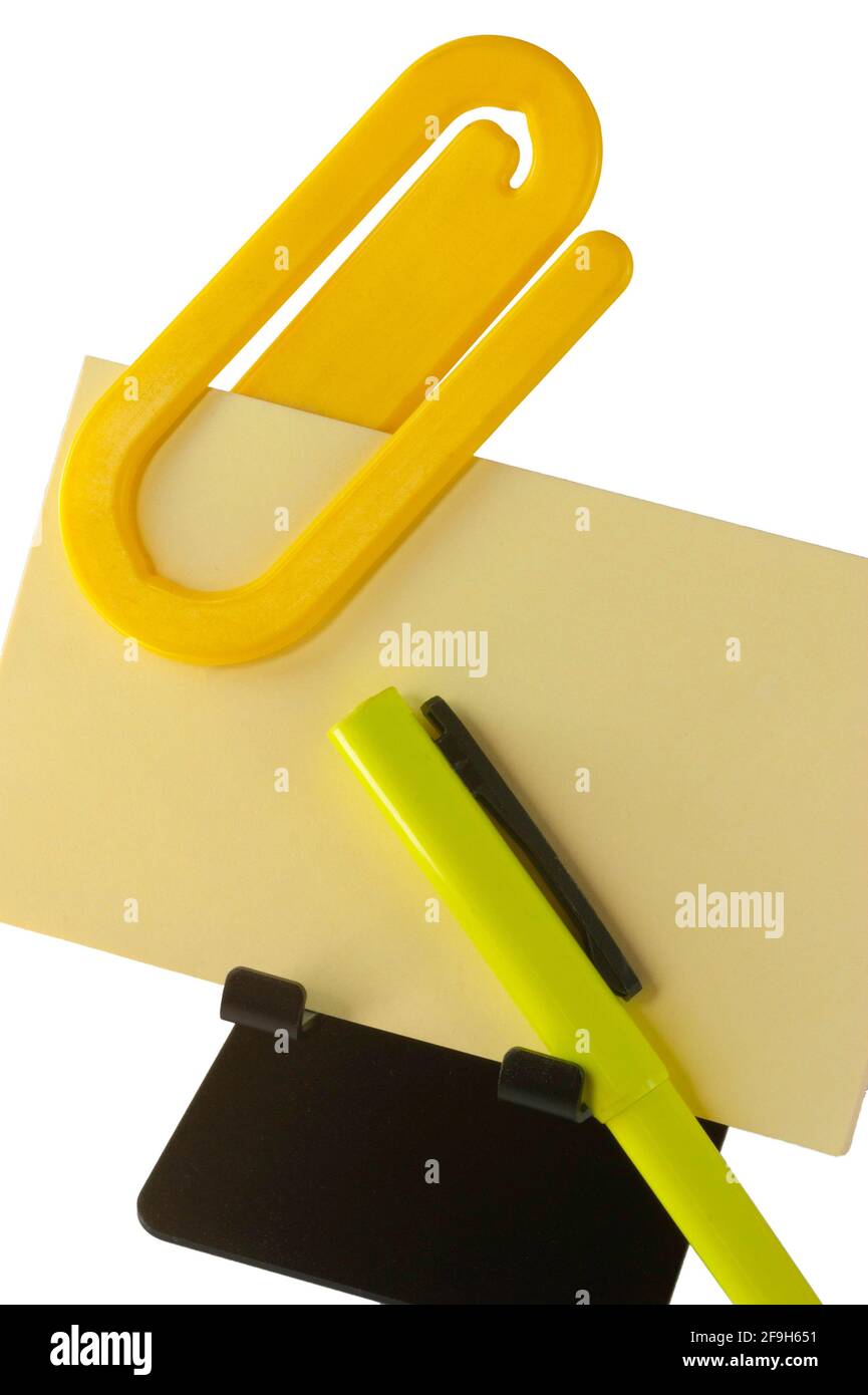 Office memo is ready to write on yellow paper with pen and paperclip ...