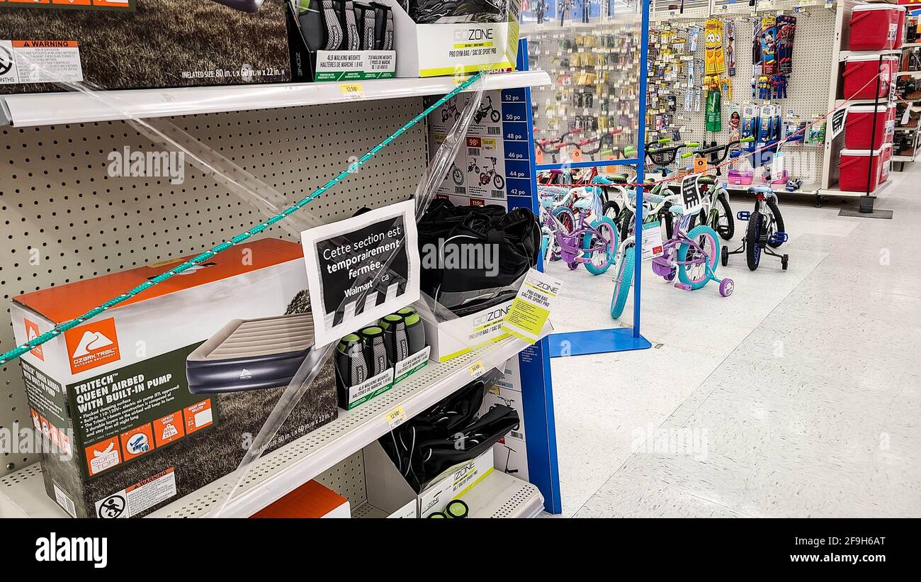 Tape closing off non-essential shopping items in a major supermarket. A ...