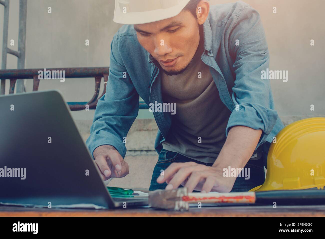 Man using computer technology working in construction site Stock Photo ...