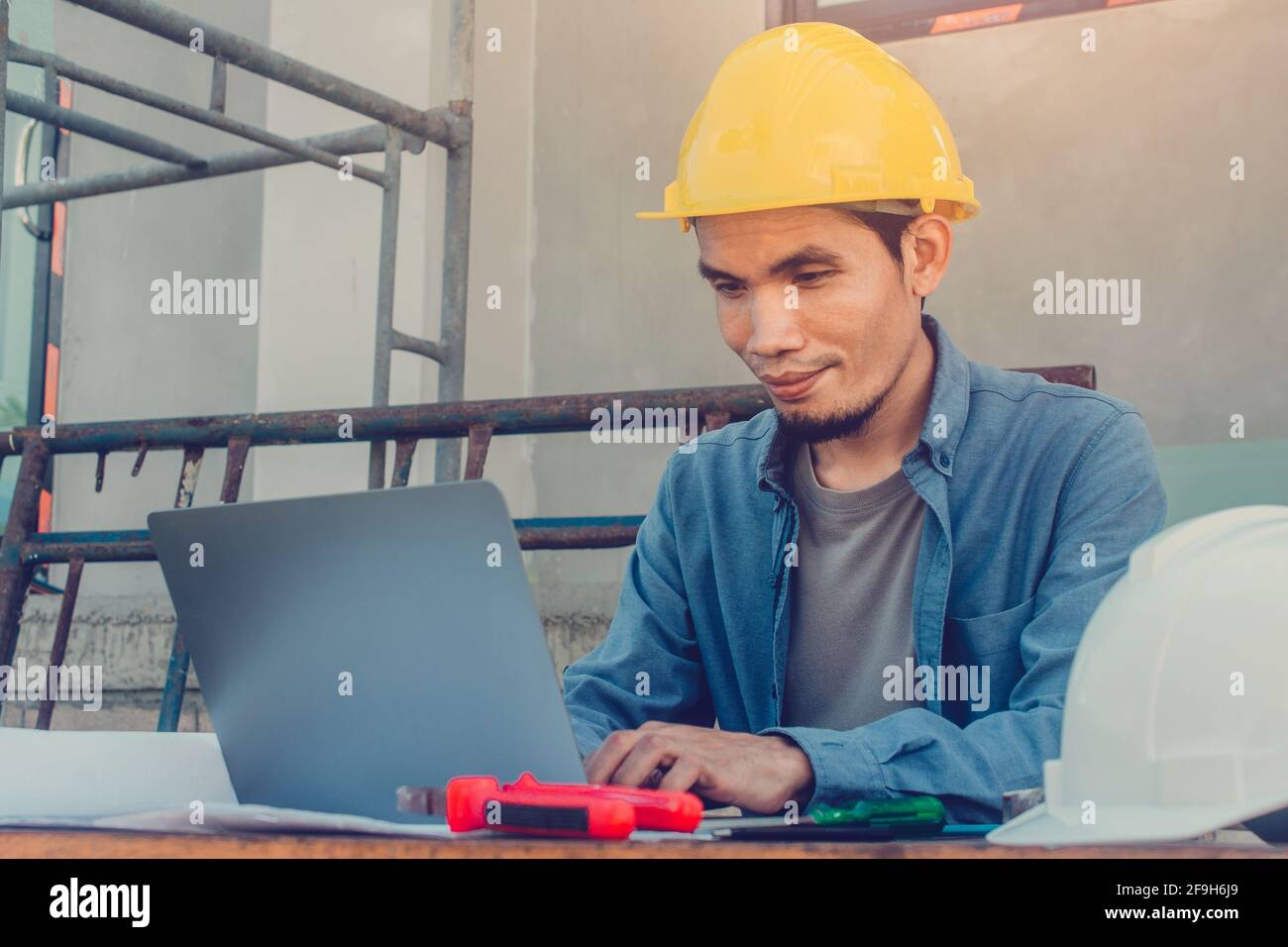 Man using computer technology working in construction site Stock Photo ...