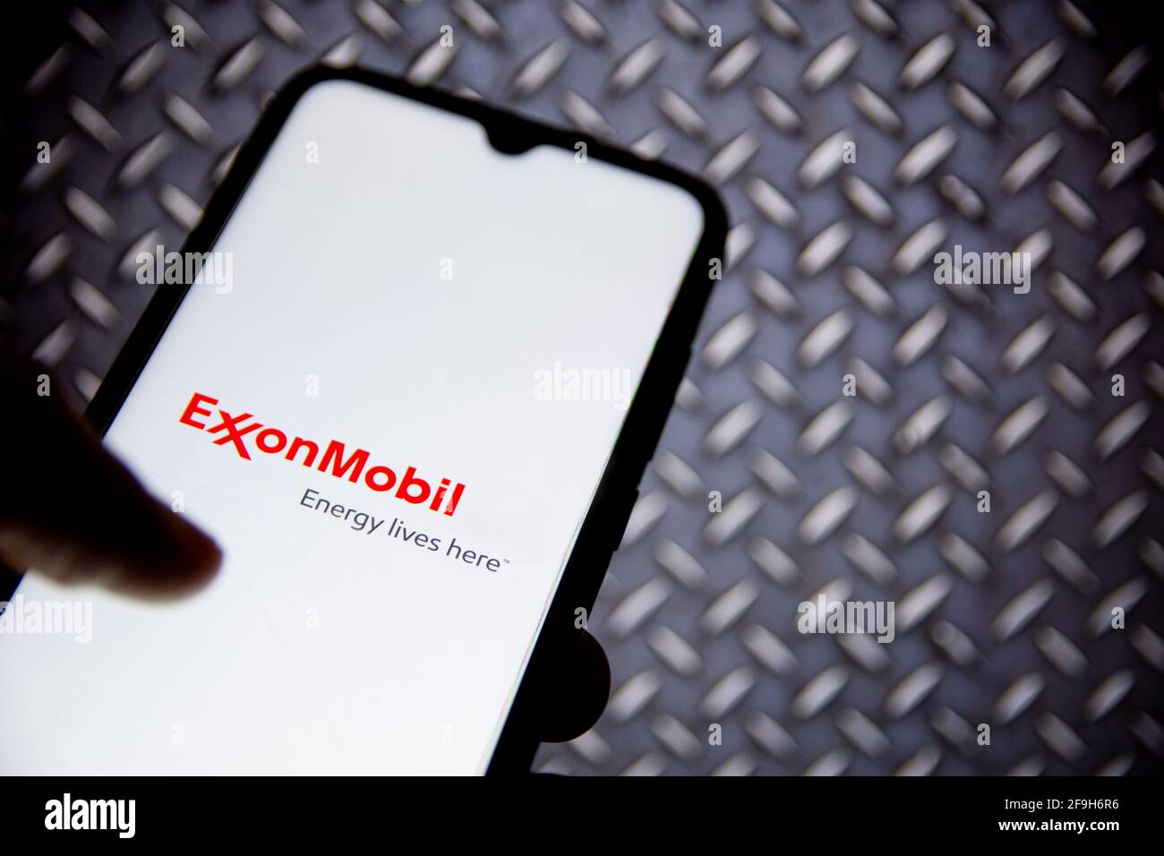 In this photo illustration an ExxonMobil logo seen displayed on a ...