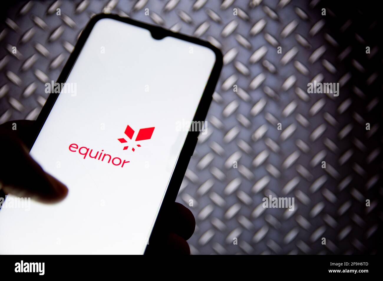 In this photo illustration a Equinor logo seen displayed on a ...