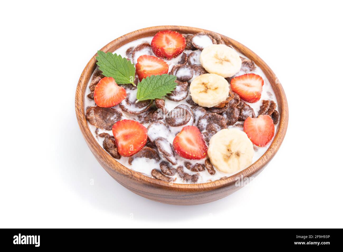 Chocolate cornflakes with milk and strawberry in wooden bowl isolated ...