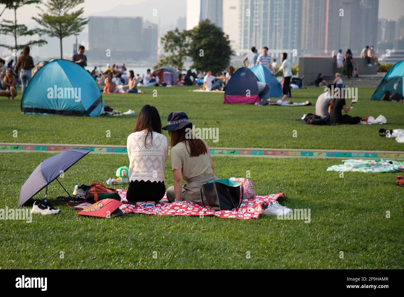 20 3 2021: two Chinese women , friends families sitting and relaxing on ...