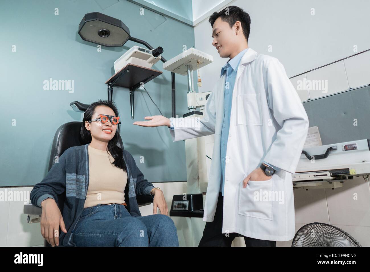 a doctor is giving directions to a female patient when she is about to ...