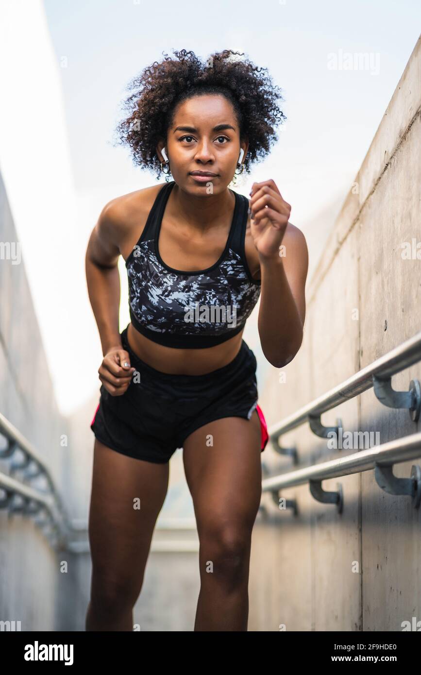 Afro athlete woman running outdoors Stock Photo - Alamy