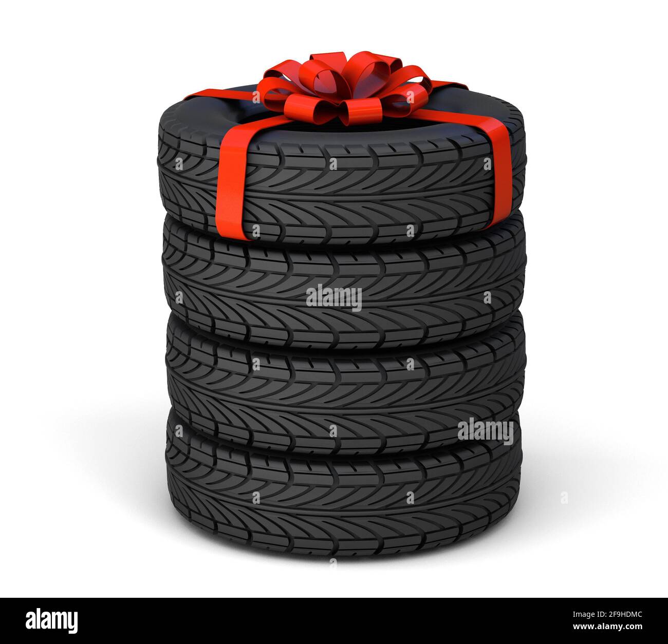 Tire as a gift. Set of three tires, one tied with a red gift ribbon ...
