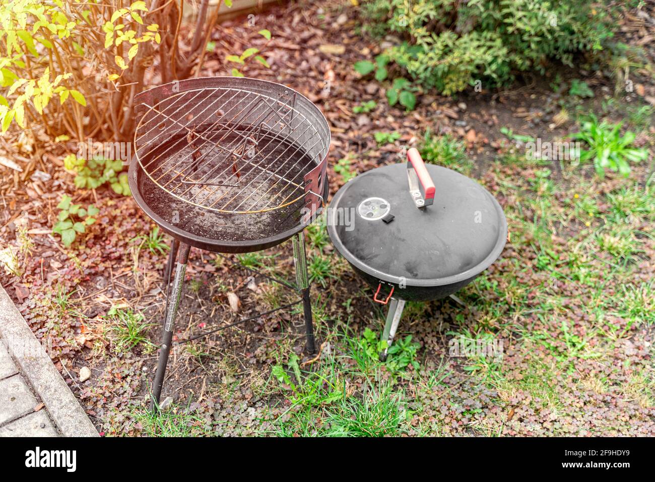 An old shabby metal barbecue grill stands in the backyard Stock Photo ...