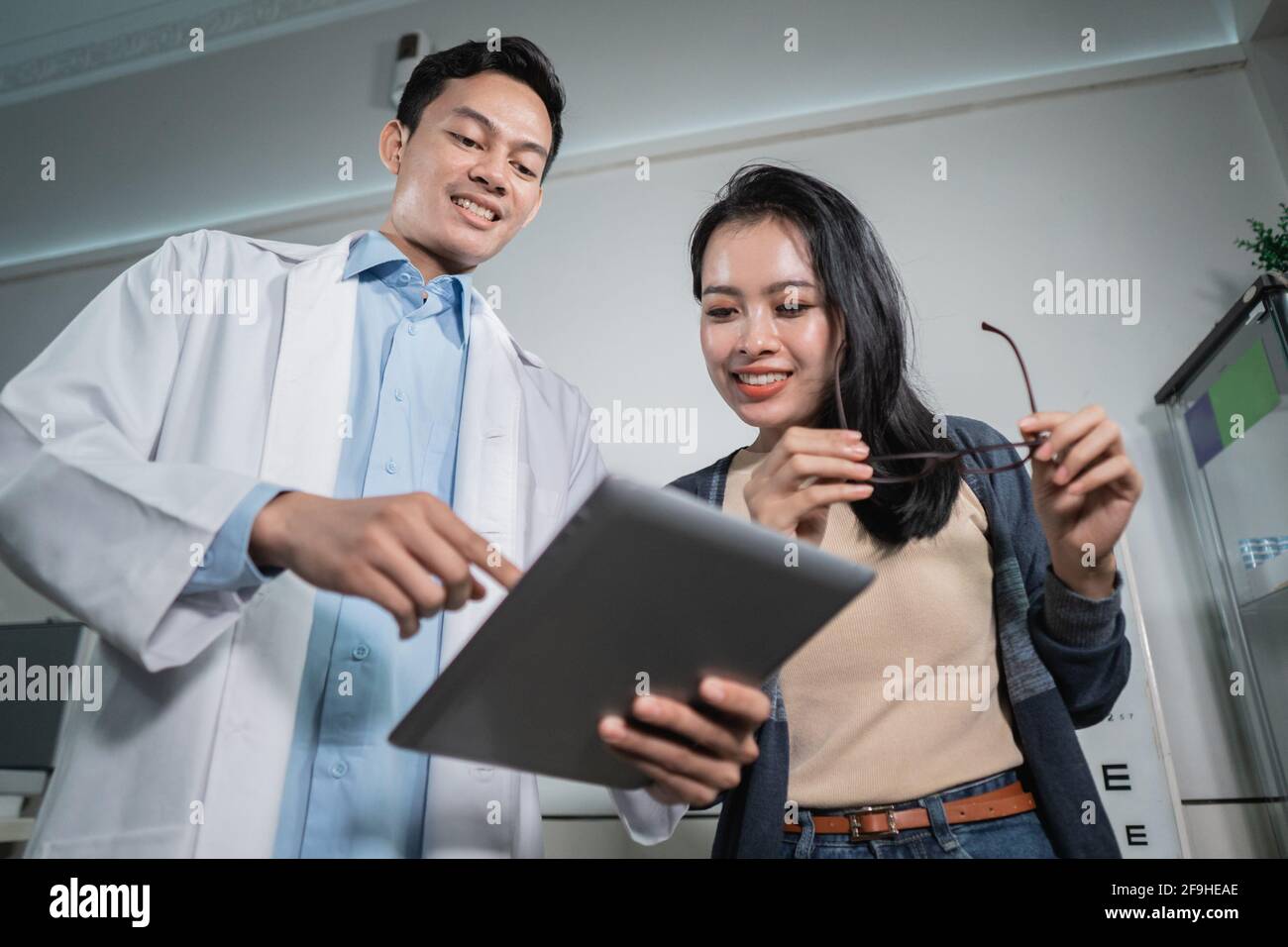 male doctor is giving the results of an analysis to a female patient ...