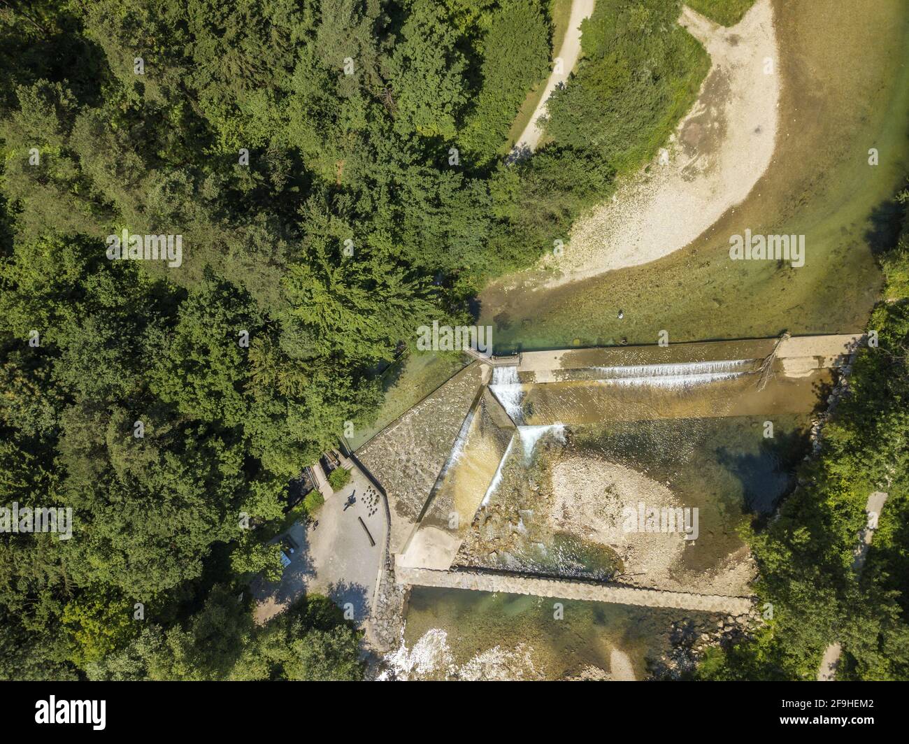 Aerial view of a shallow river surrounded by thick forest in the ...
