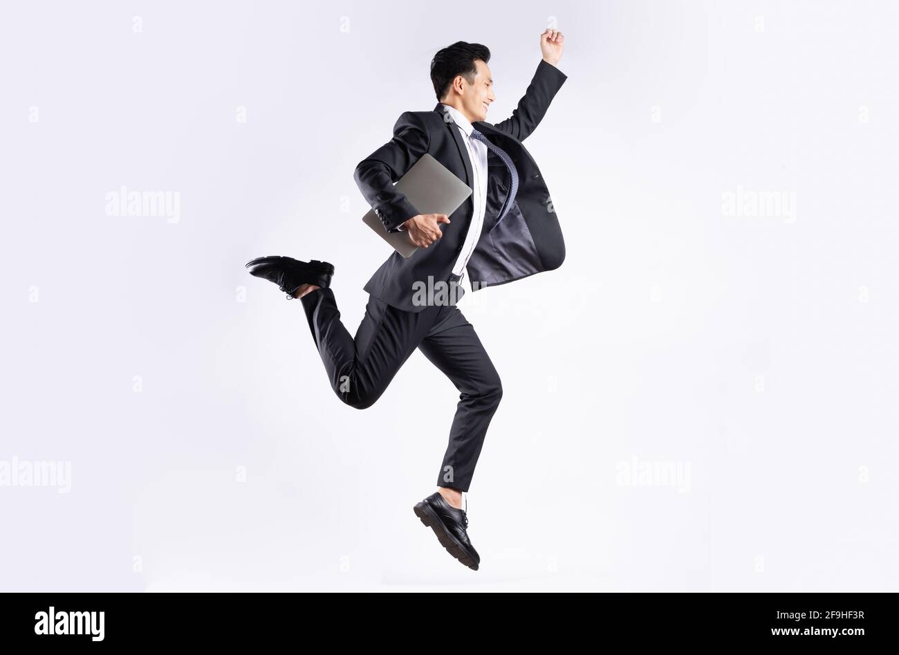 Man suit jumping laptop hi-res stock photography and images - Alamy