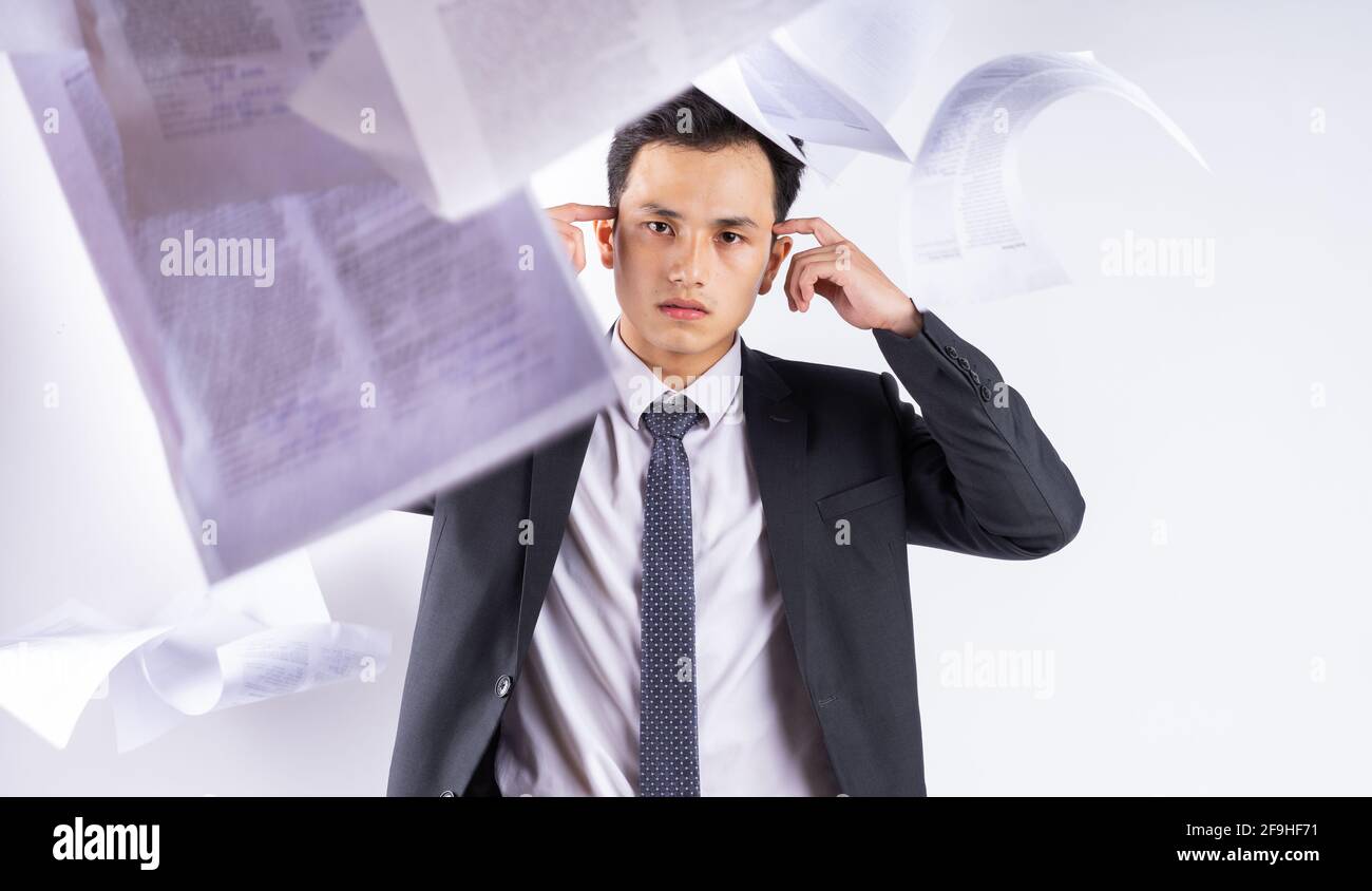 Stressed Asian businessman on white background Stock Photo - Alamy