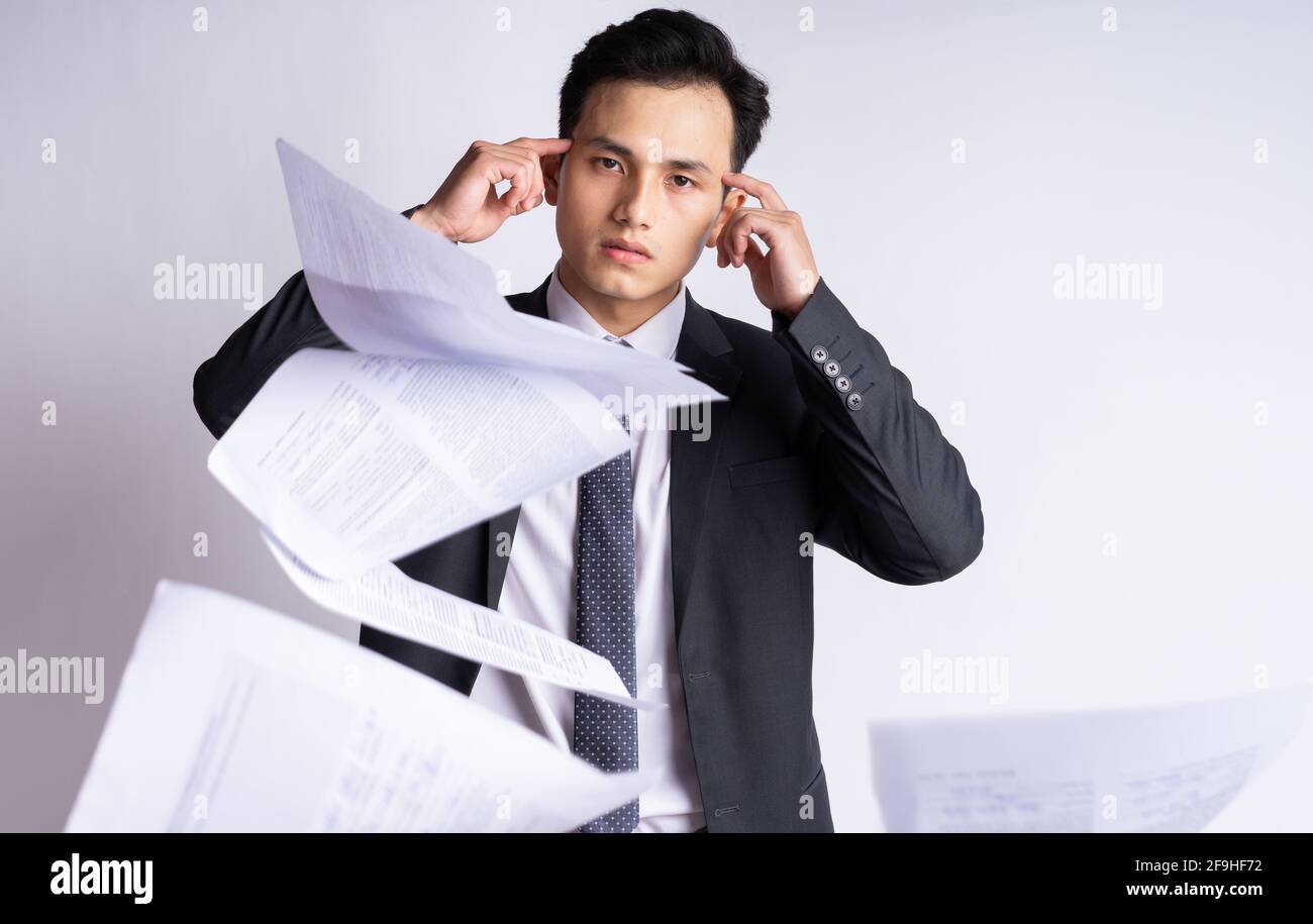 Stressed Asian businessman on white background Stock Photo - Alamy