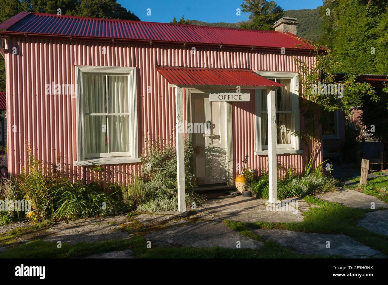 Paradise New Zealand - March 4 2015; Pink rustic office building at ...